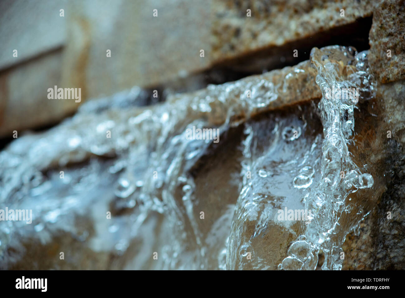 A bead of water formed by flowing water Stock Photo - Alamy