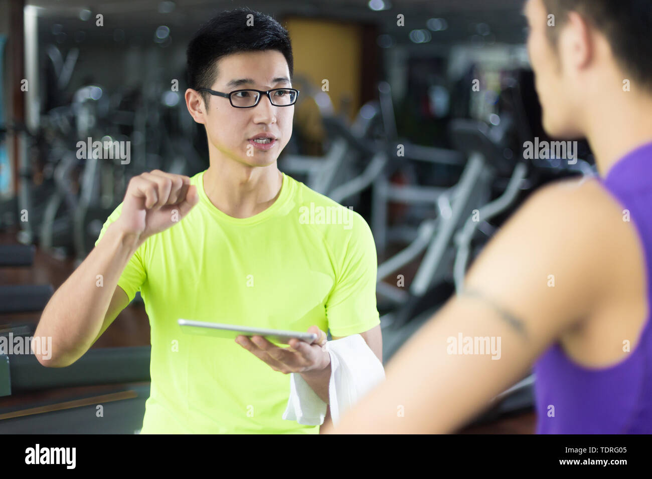 young asian people talking by tablet in modern gym Stock Photo - Alamy