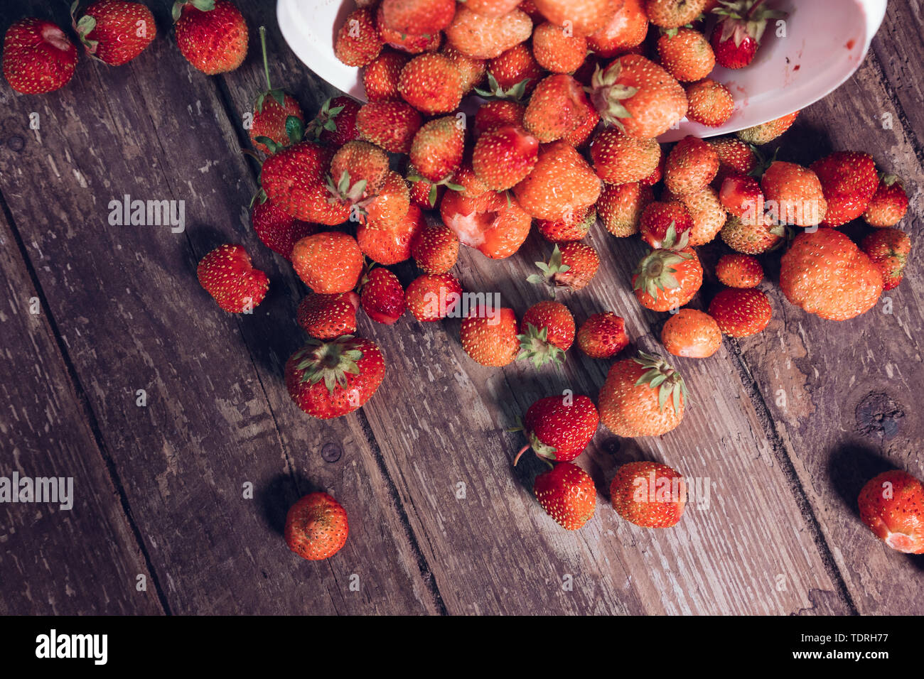 sprinkled natural and fresh strawberry from a white bucket Stock Photo ...