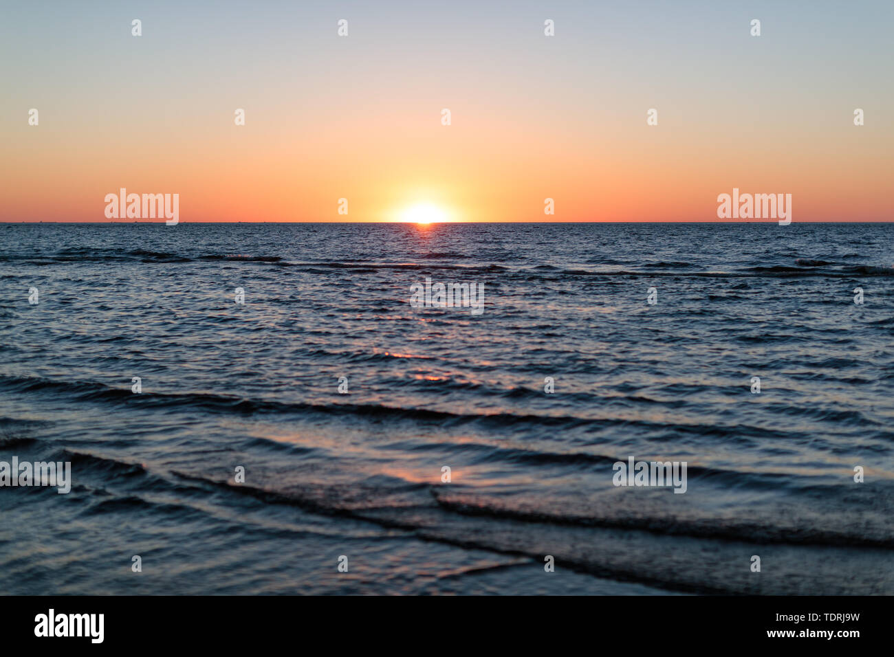 evening landscape of the sunset and the sea as well as the tide of ...