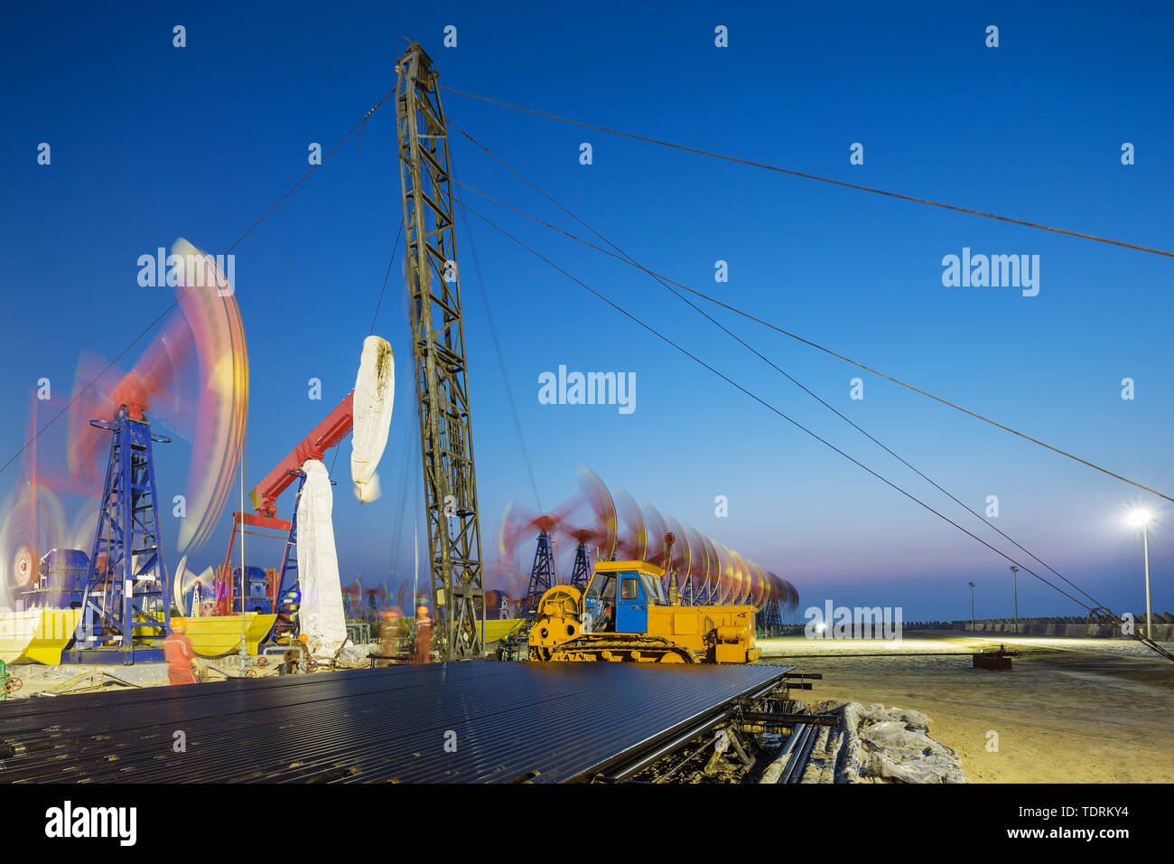 Oil-rig of oilfield day and night Stock Photo - Alamy