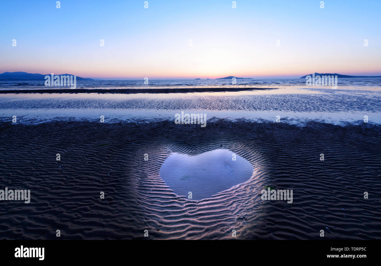 The sand pit dug by the sea people, washed away by the waves, formed a ...