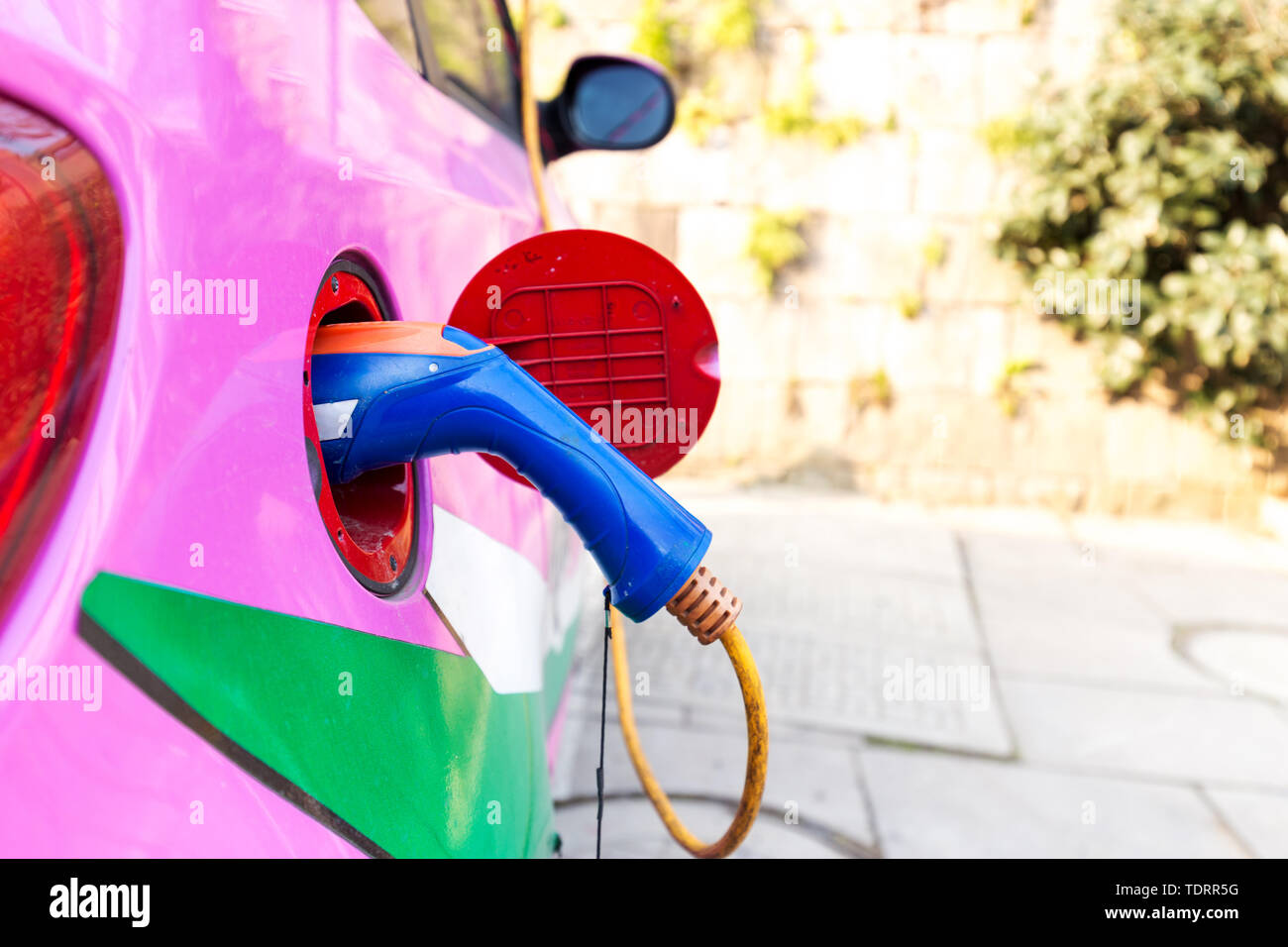 Blue gas gun and pink car Stock Photo - Alamy