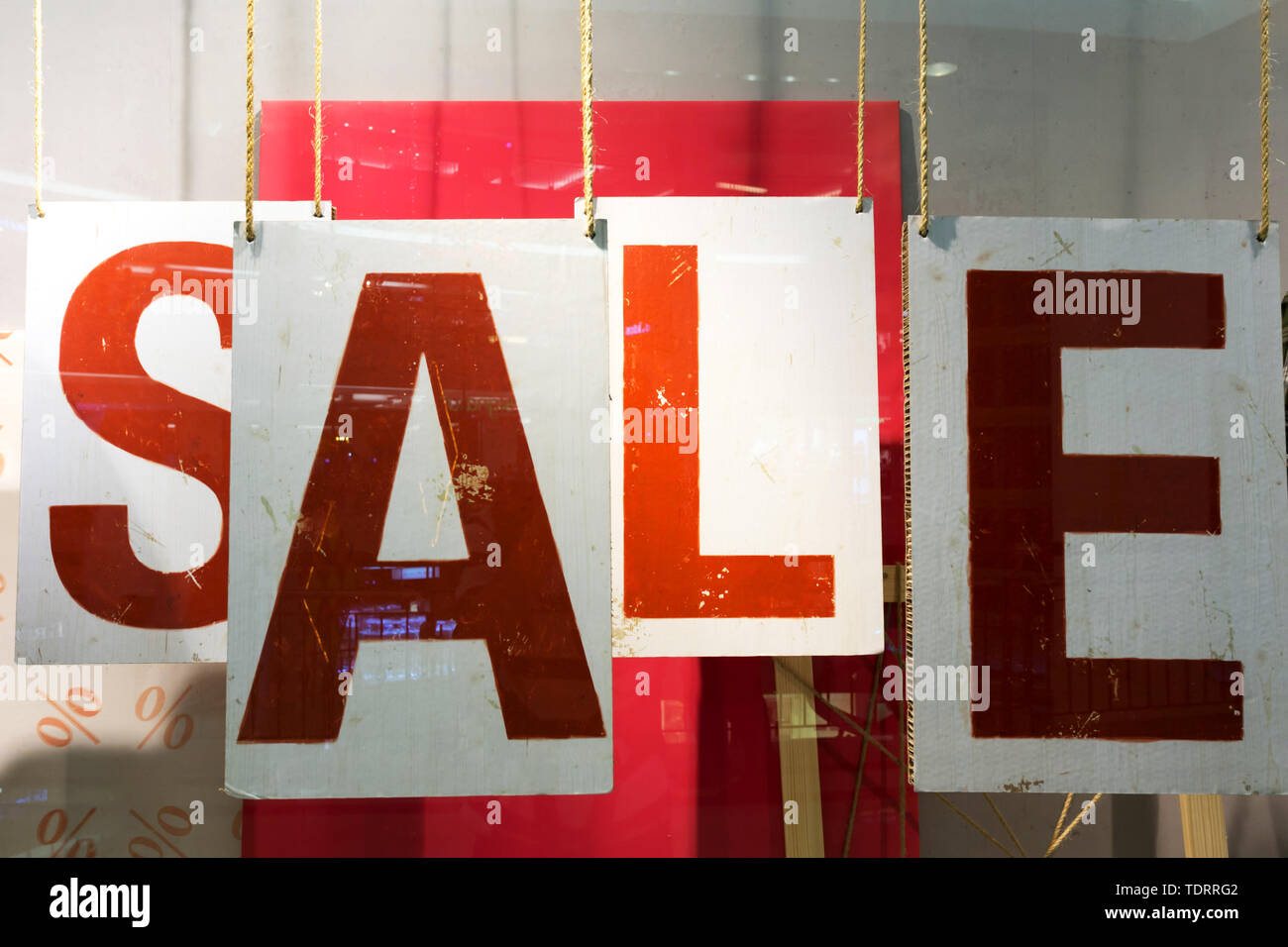 clothes storefront window with sale poster Stock Photo - Alamy