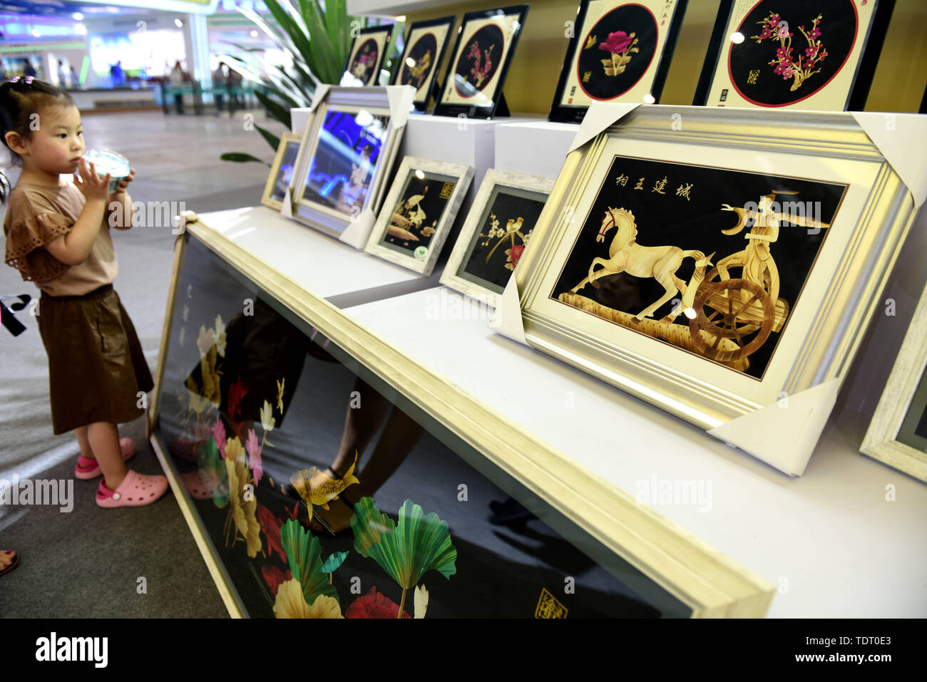 Hefei, China's Anhui Province. 17th June, 2019. A child views art works ...