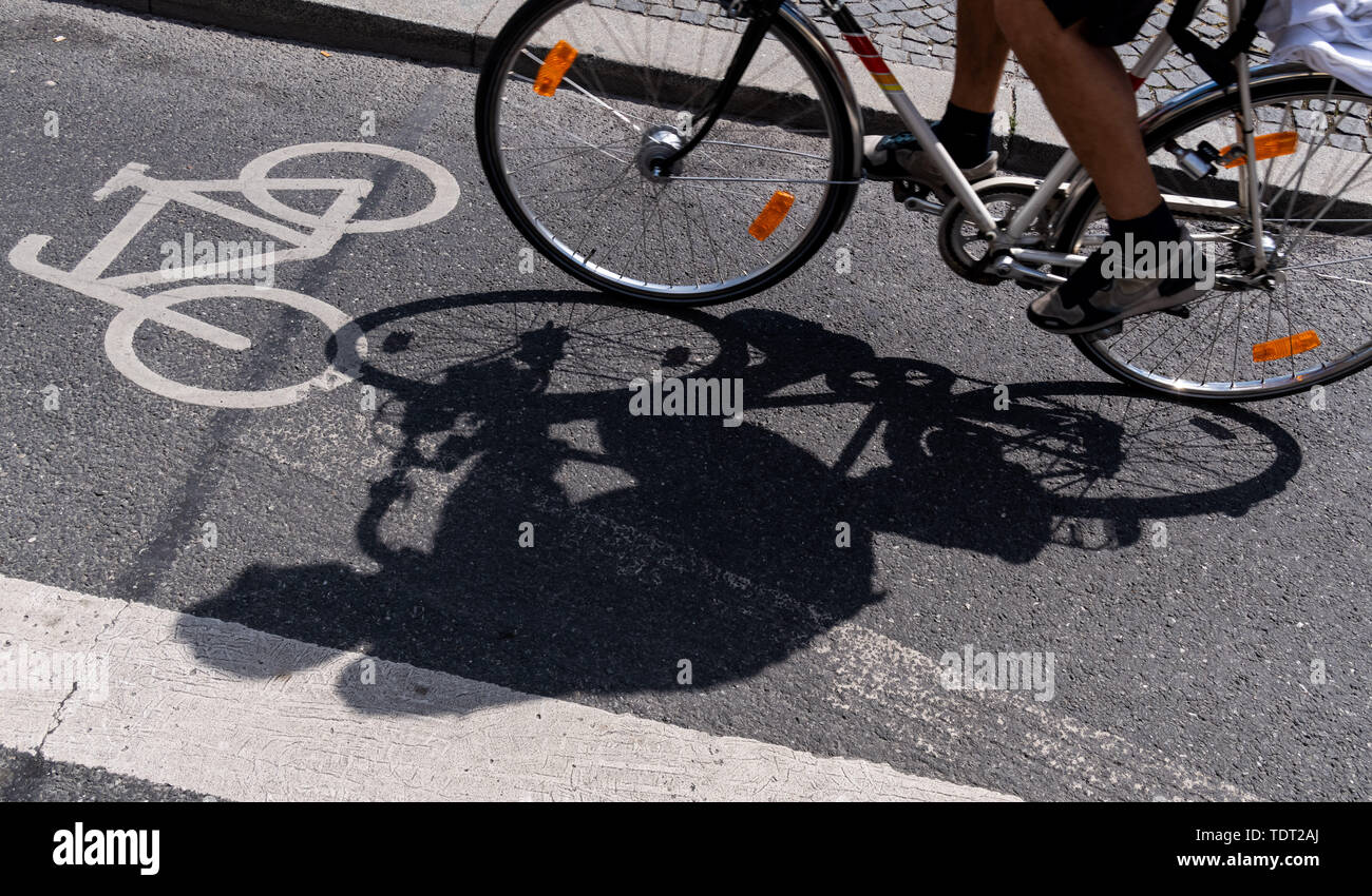 Munich, Germany. 17th June, 2019. A cyclist casts his shadow on a ...