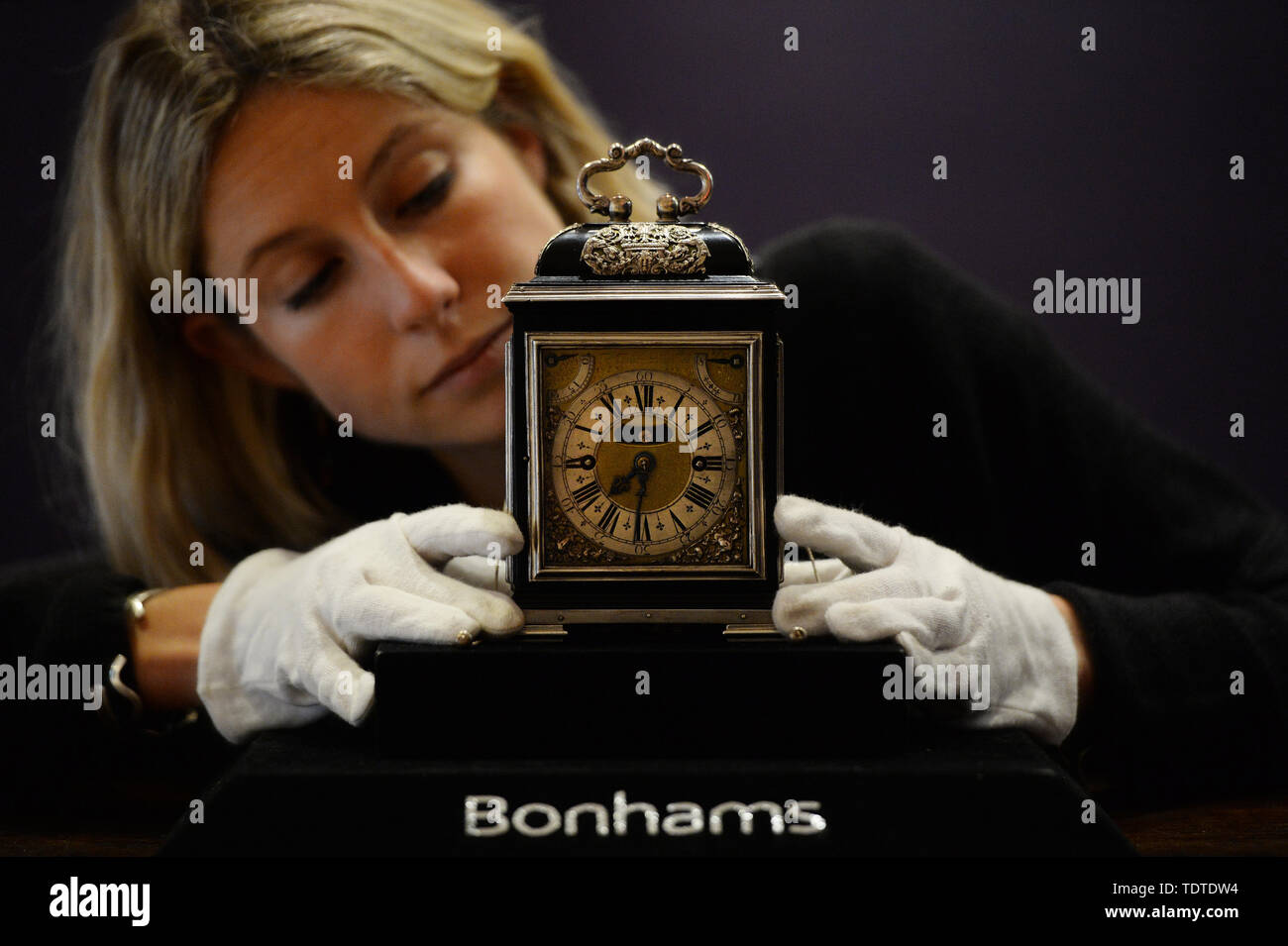 A gallery assistant looks at the King William & Queen Mary Royal ...