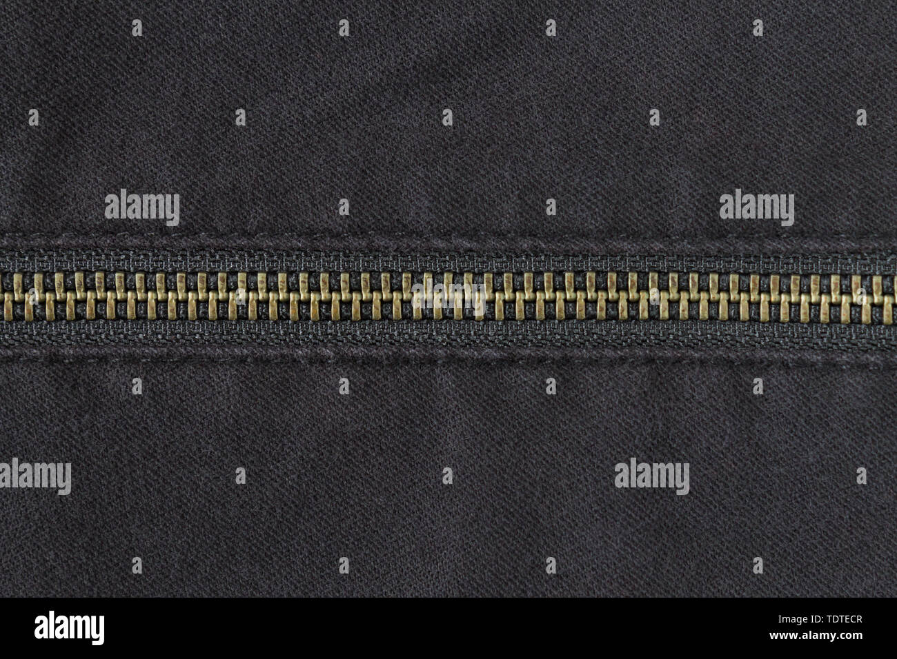 Brass Zip on Black Jeans Texture Background. Closed Brass Zip on Black ...
