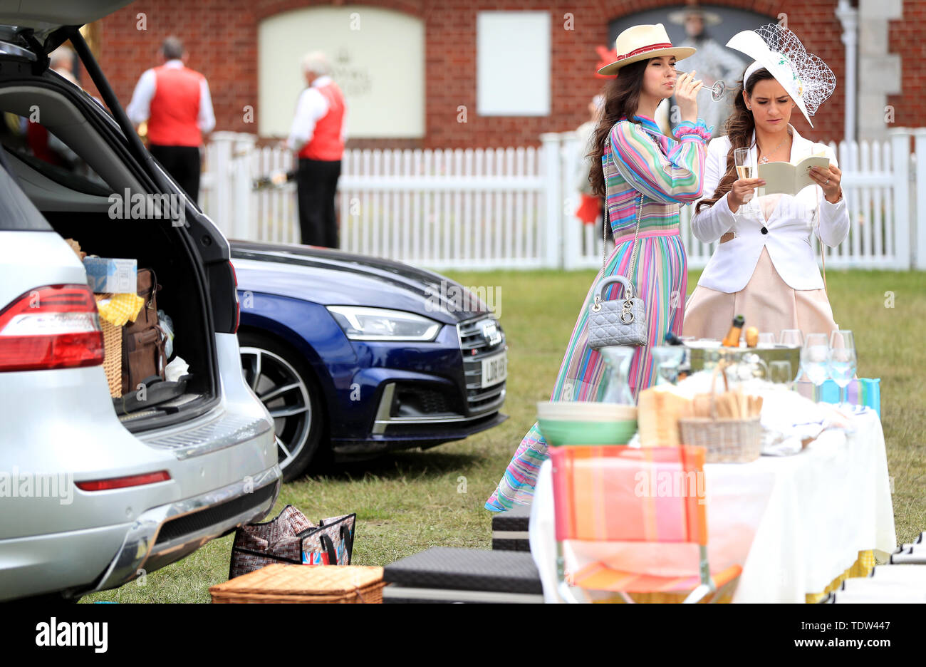 Racegoers enjoy a picnic outside their cars during day three of Royal ...