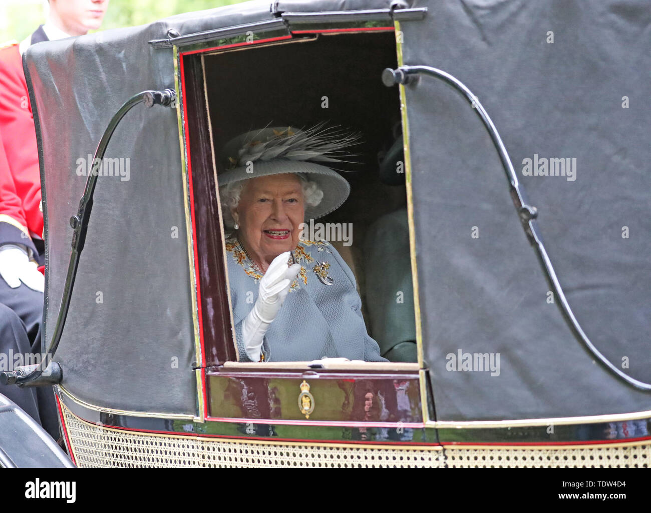 Queen Elizabeth II seen in a horse-drawn carriage on her journey from ...