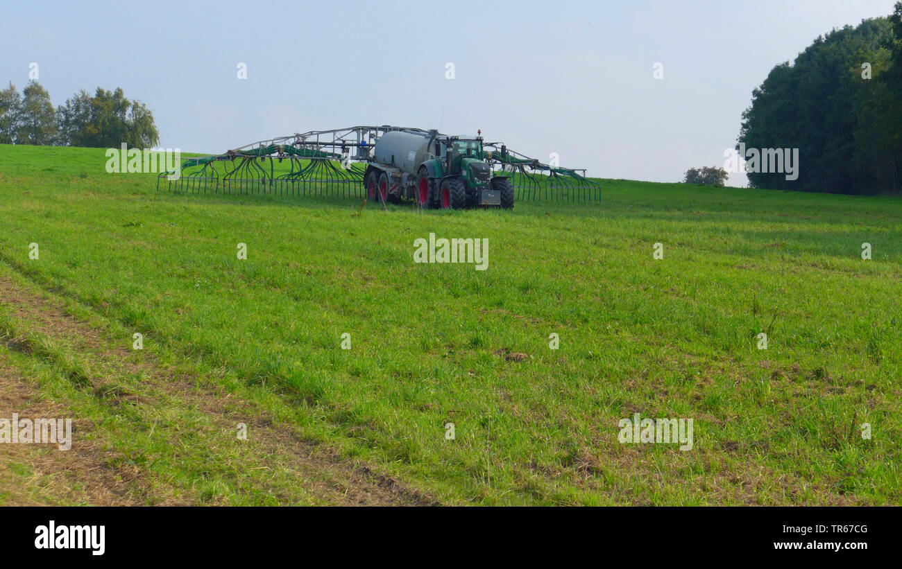liquid manure trailers manuring a meadow with liquid manure, Germany ...