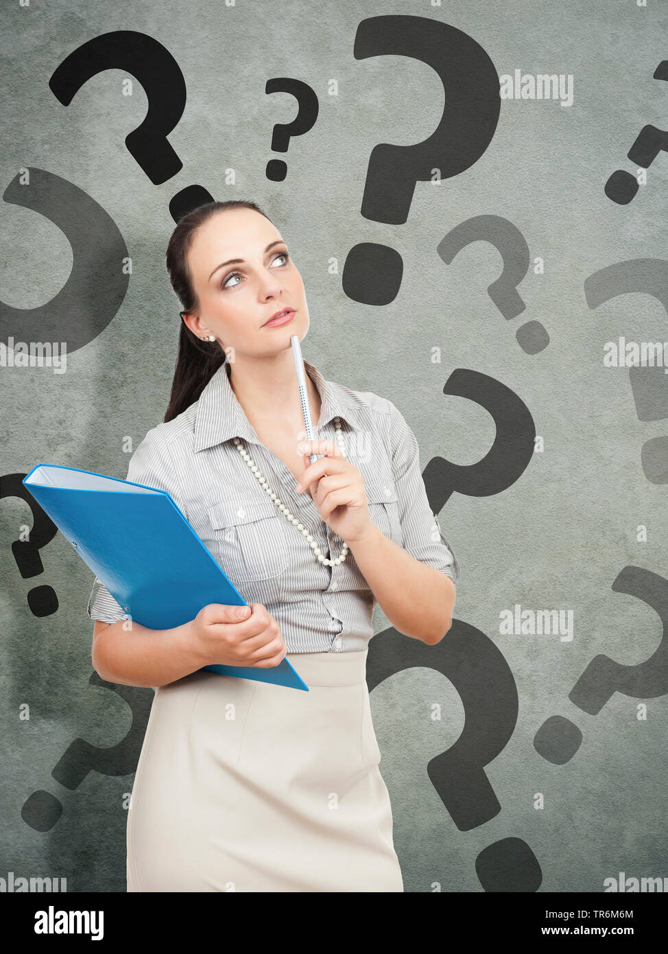 pondering businesswoman with question marks , Germany Stock Photo - Alamy