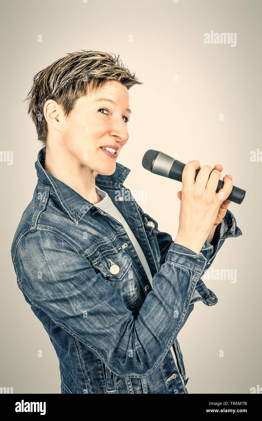 beautiful smiling women with a microphone, Germany Stock Photo - Alamy