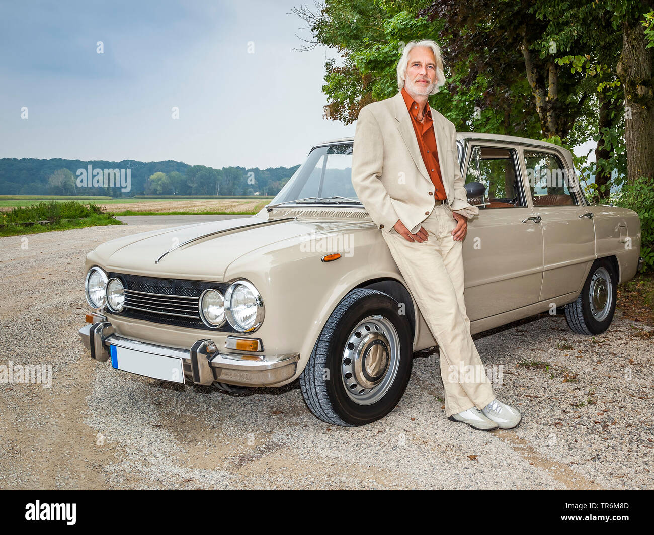 senior standing at his oldtimer Stock Photo - Alamy