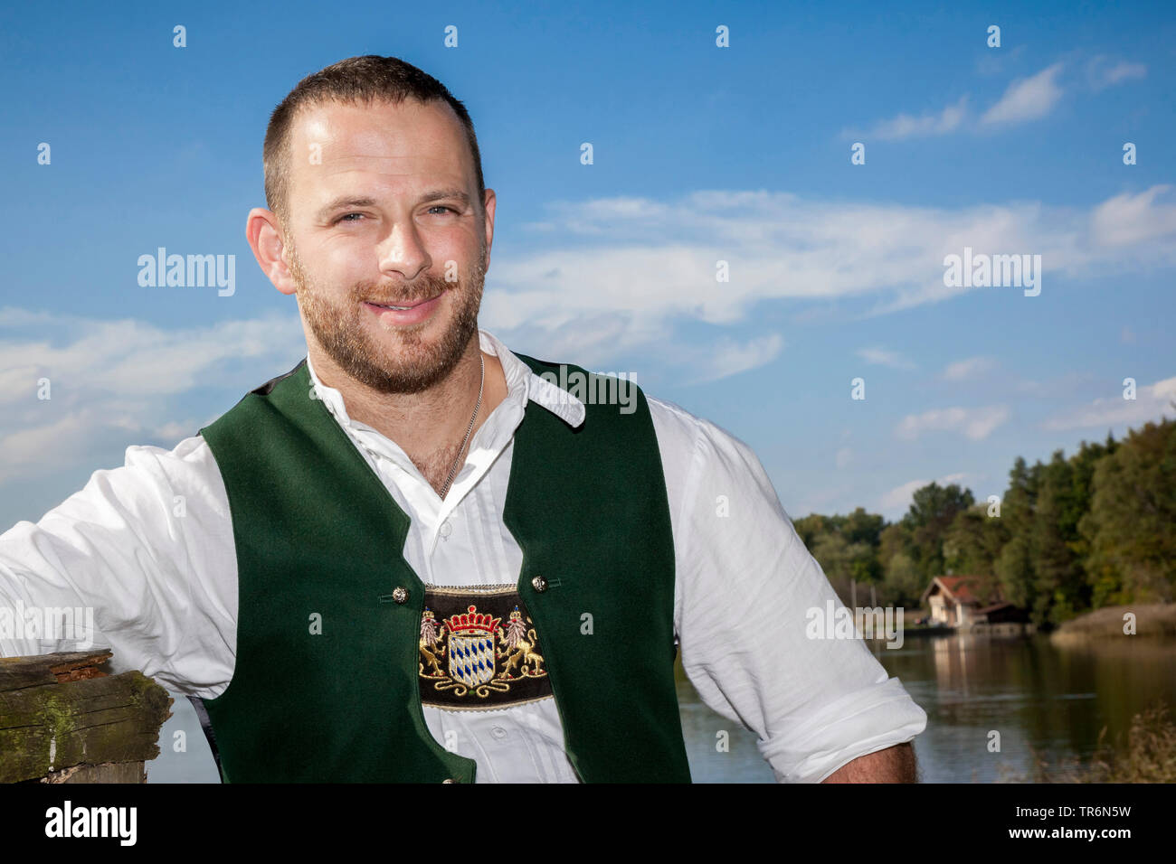 man in Bavarian traditional clothing standing at a lake, Germany ...