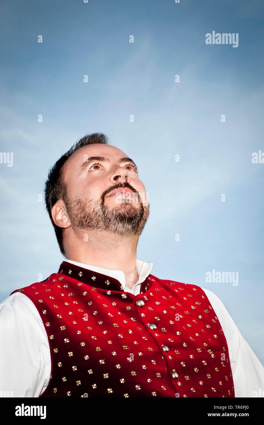 man in Bavarian traditional clothing looking up, Germany, Bavaria Stock ...