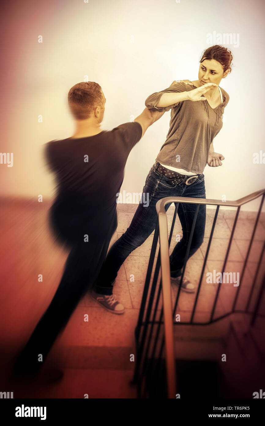 man attacking a woman in the stairway, Germany Stock Photo - Alamy