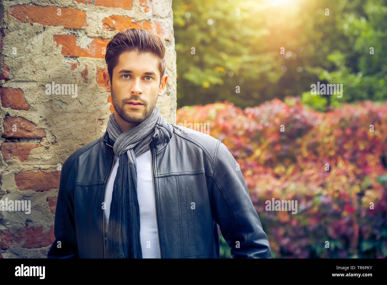 young attractive man with leather jacket in a park, Germany Stock Photo ...