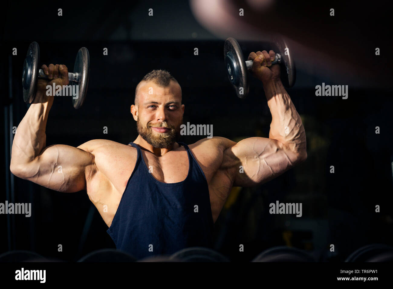 bodybuilder training in a fitness centre in front of a mirror, Germany ...