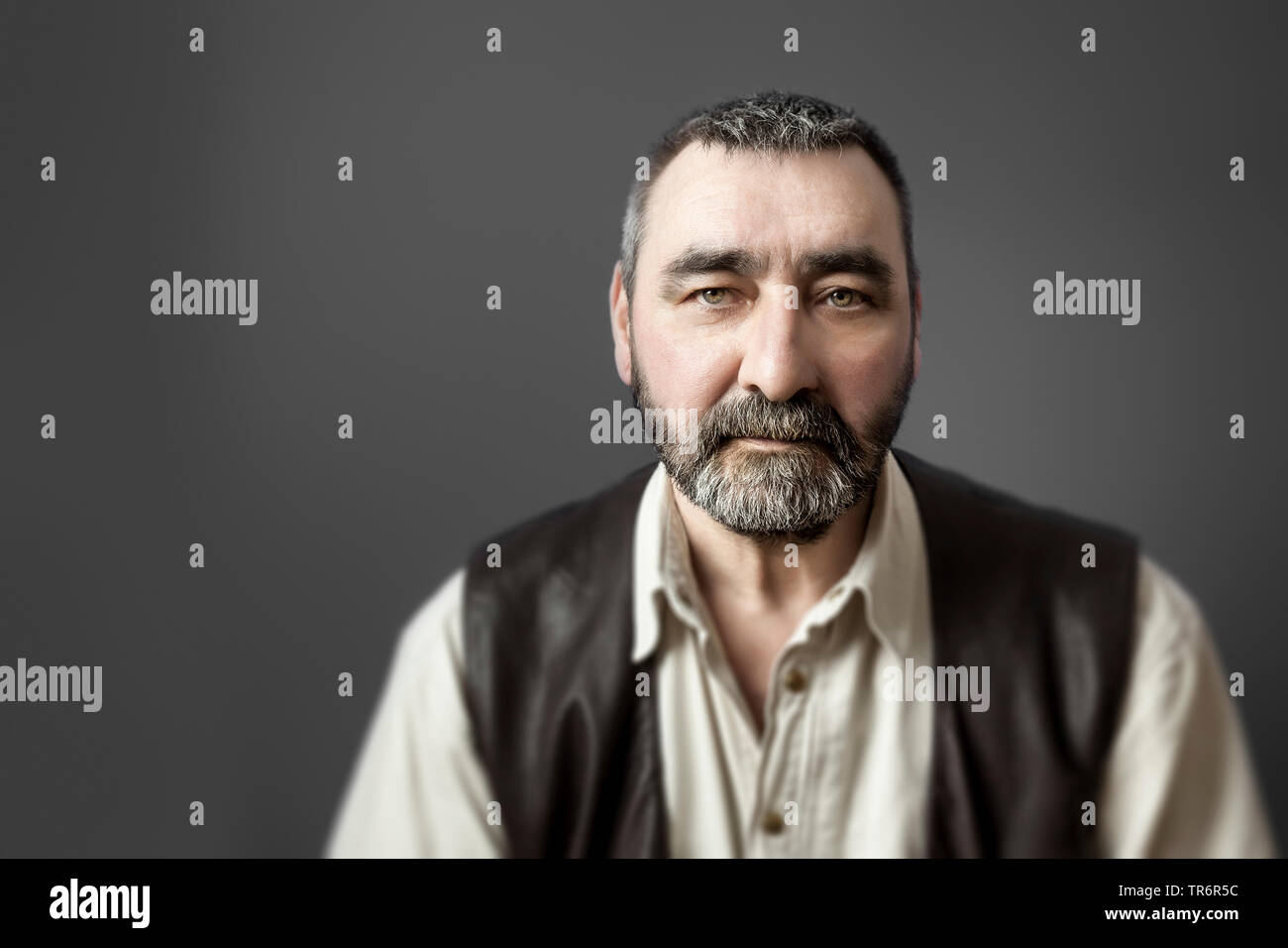 serious man with beard in front of black background, Germany Stock ...
