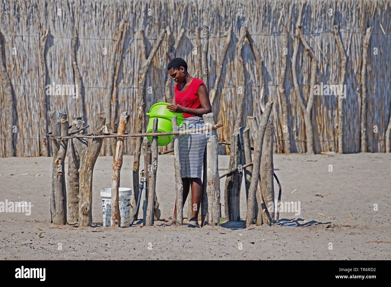Woman getting water well bucket hi-res stock photography and images - Alamy