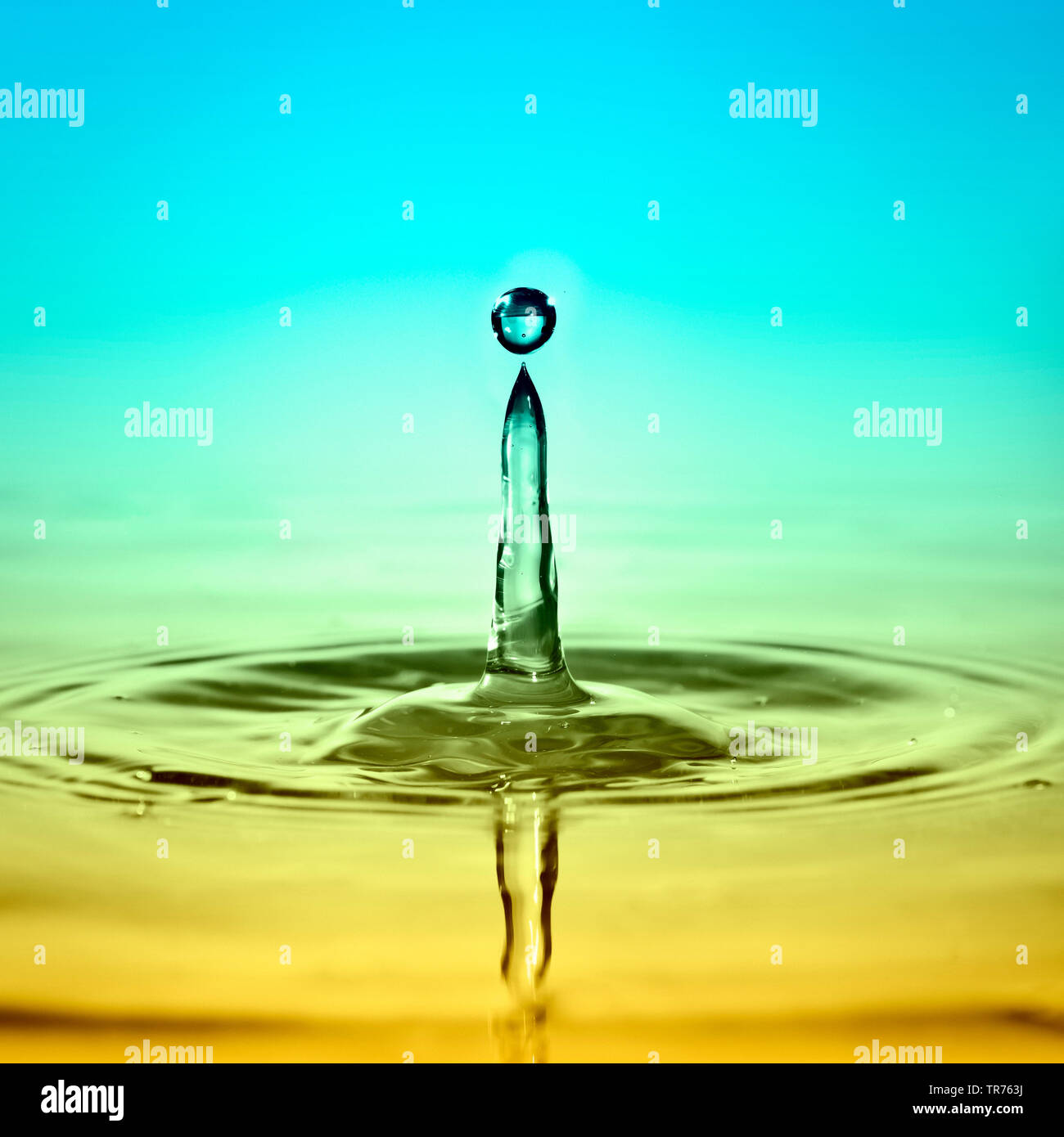 Falling drop waterdrop surface yellow hi-res stock photography and ...