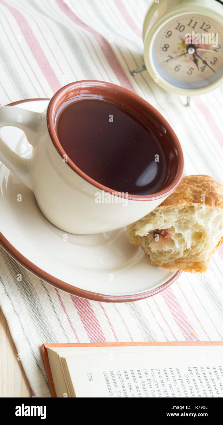 reading a book with a cup of tea Stock Photo - Alamy
