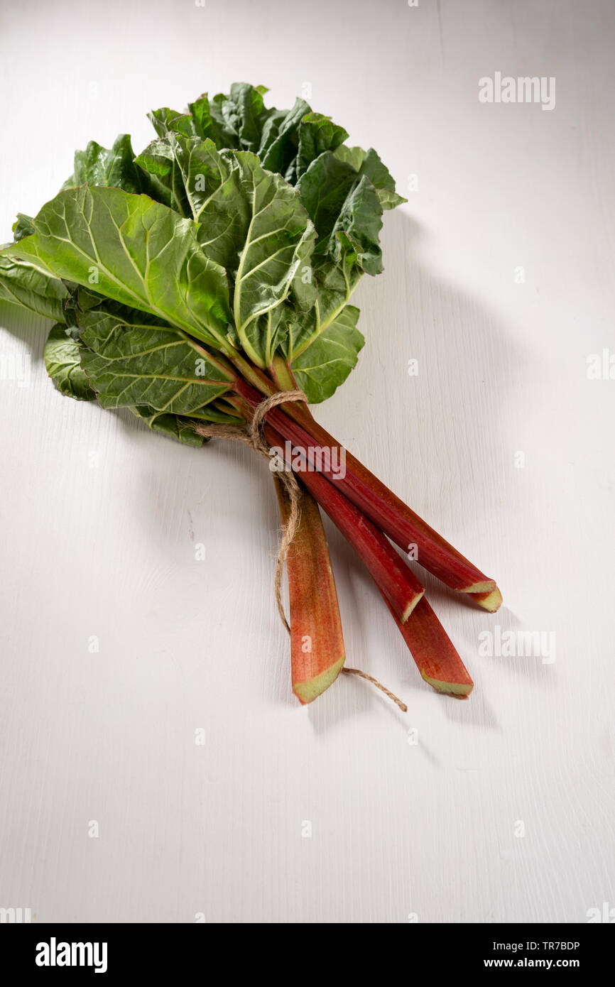 Bunch of raw rhubarb steams on white Stock Photo - Alamy