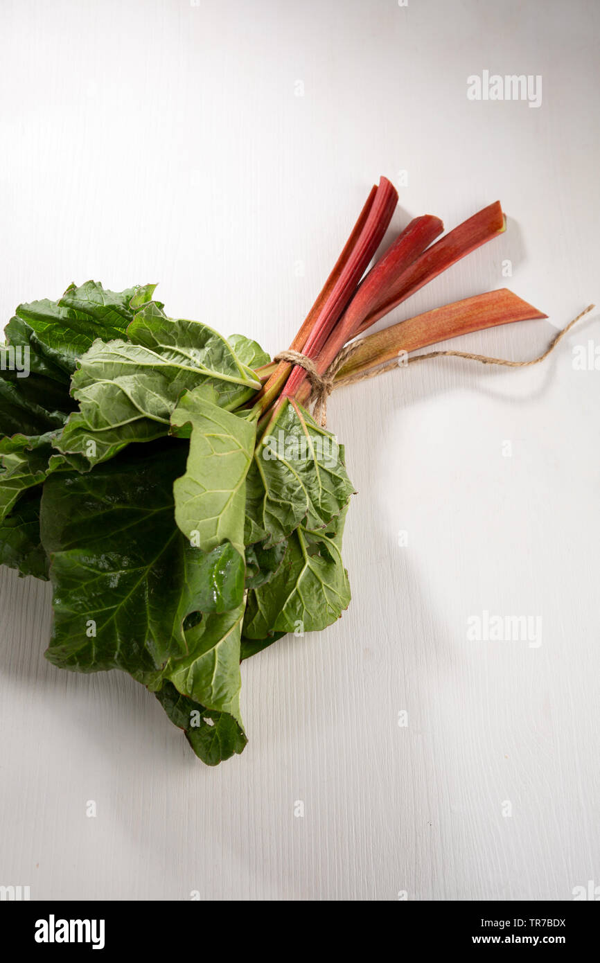 Bunch of raw rhubarb on white Stock Photo - Alamy