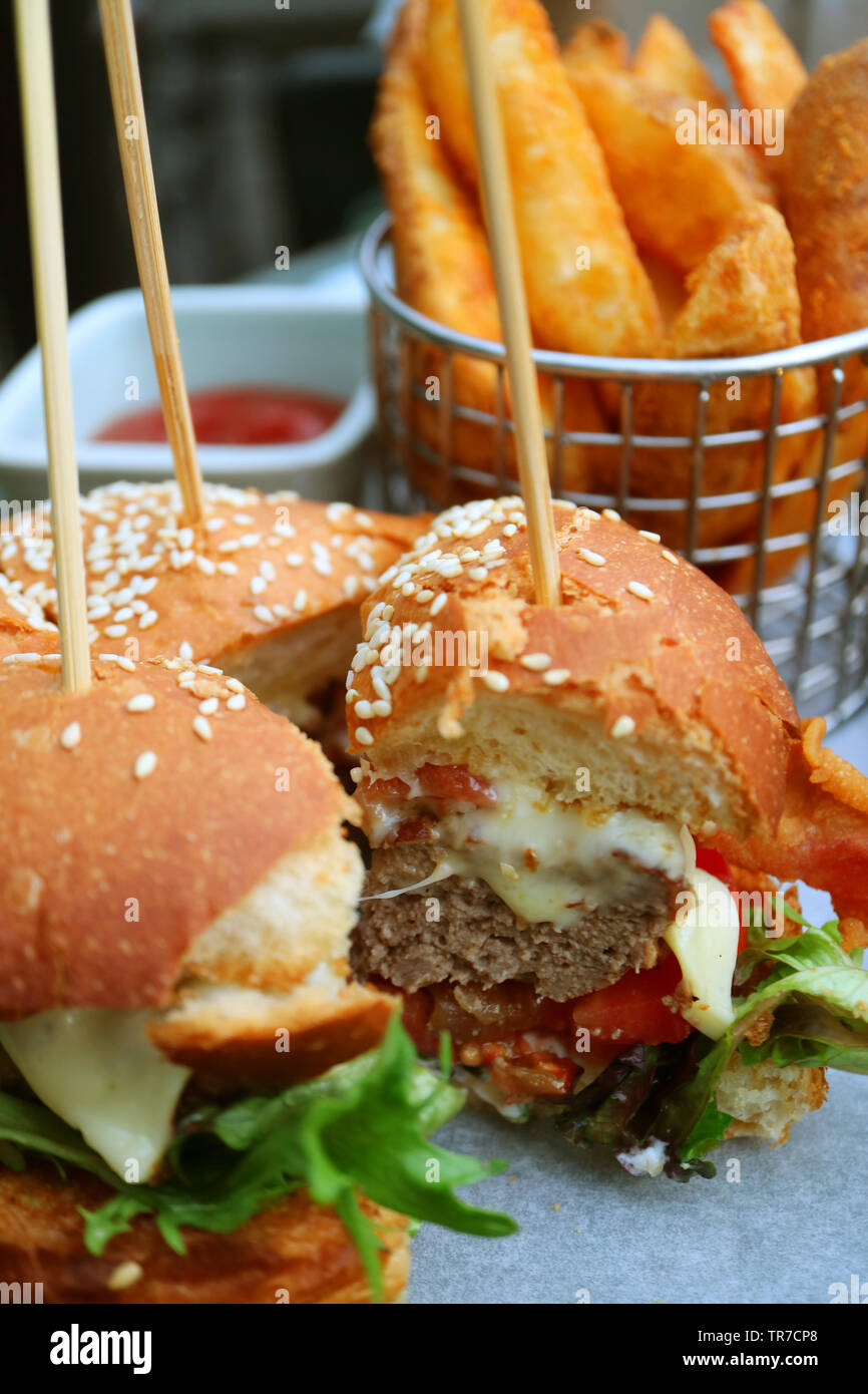 Vertical Image of Cut Thick and Cheesy Burger with French Fries Stock ...