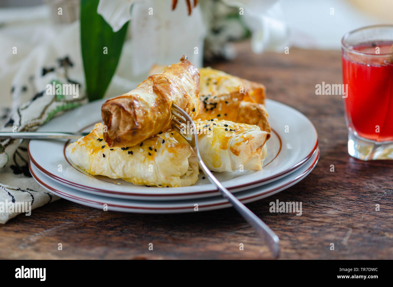 A glass of Turkish Sherbet and slices of freshly baked homemade borek ...