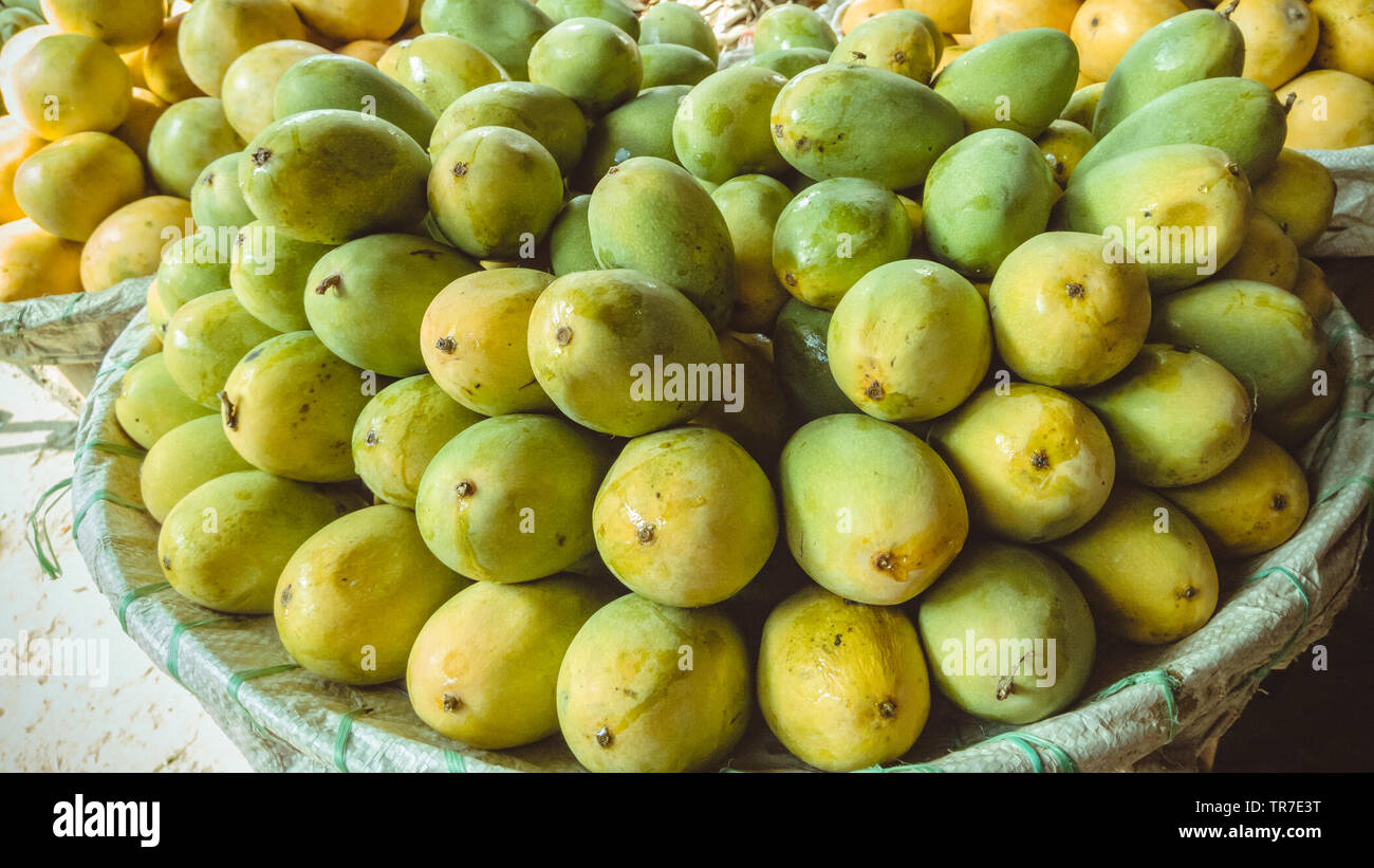 Heap of fresh ripe Dashehari mangoes in basket at fruits shop Stock ...