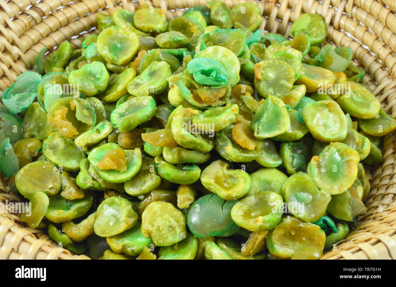 Cooked baked salt broad beans in basket isolated on white background ...