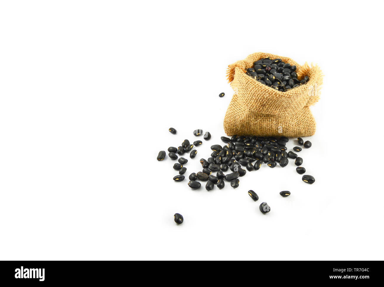 Black bean in sack isolated on white background Stock Photo - Alamy