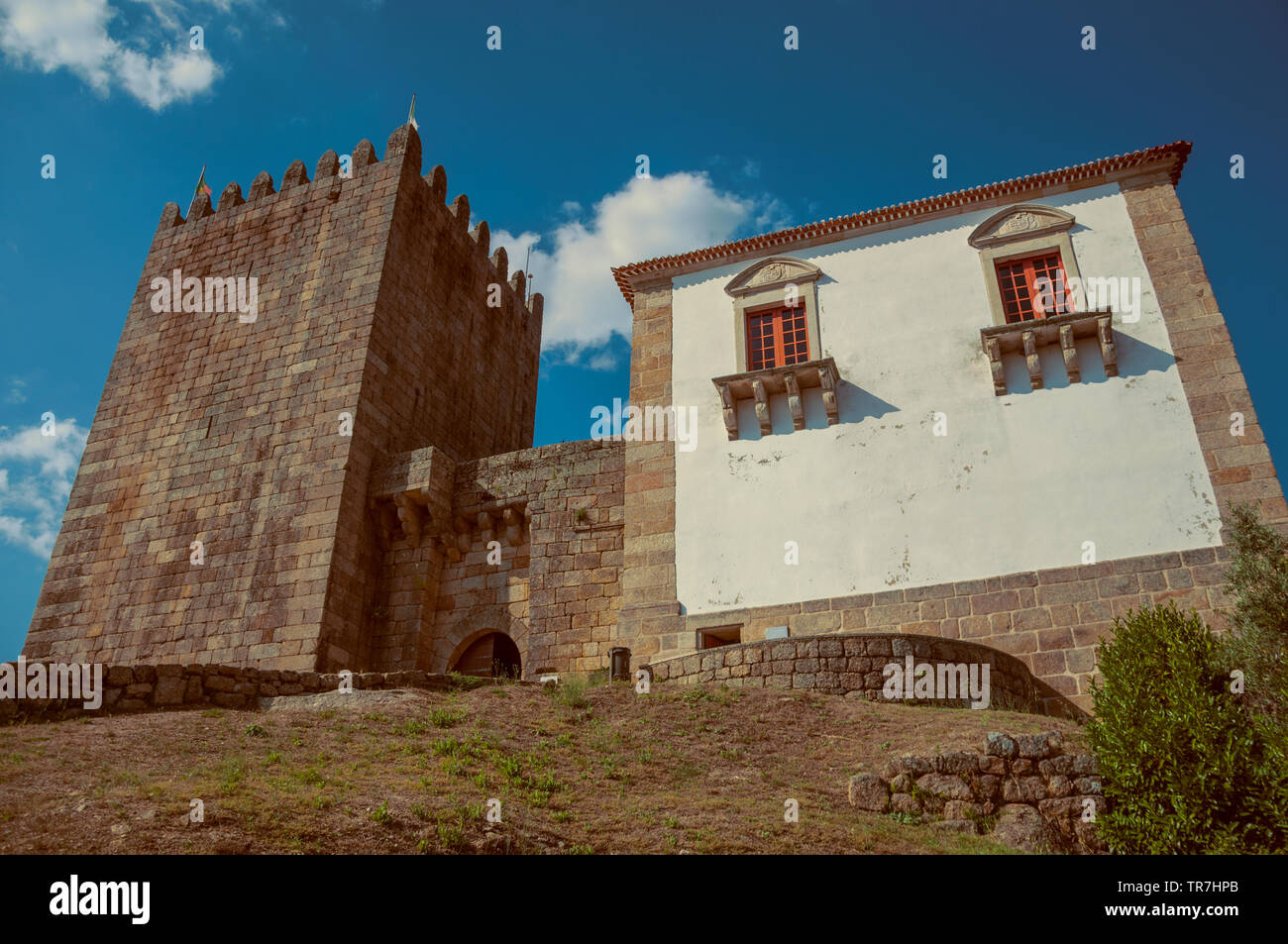 Stone walls and square tower over rocky hill at the front facade of ...
