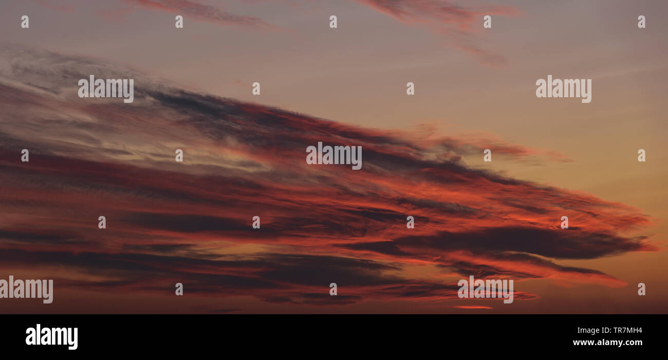 Dramatic sunset sky with orange colored clouds Stock Photo - Alamy