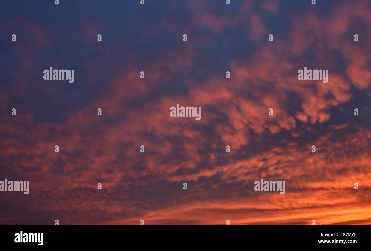 Dramatic sunset sky with orange colored clouds Stock Photo - Alamy