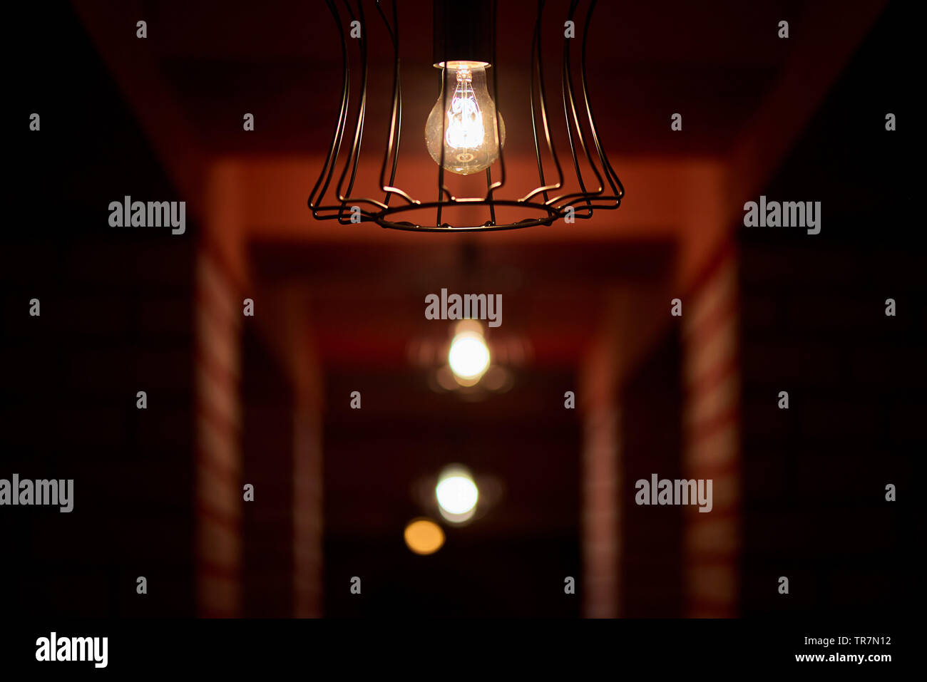 Dim light bulbs in the dark corridor Stock Photo - Alamy