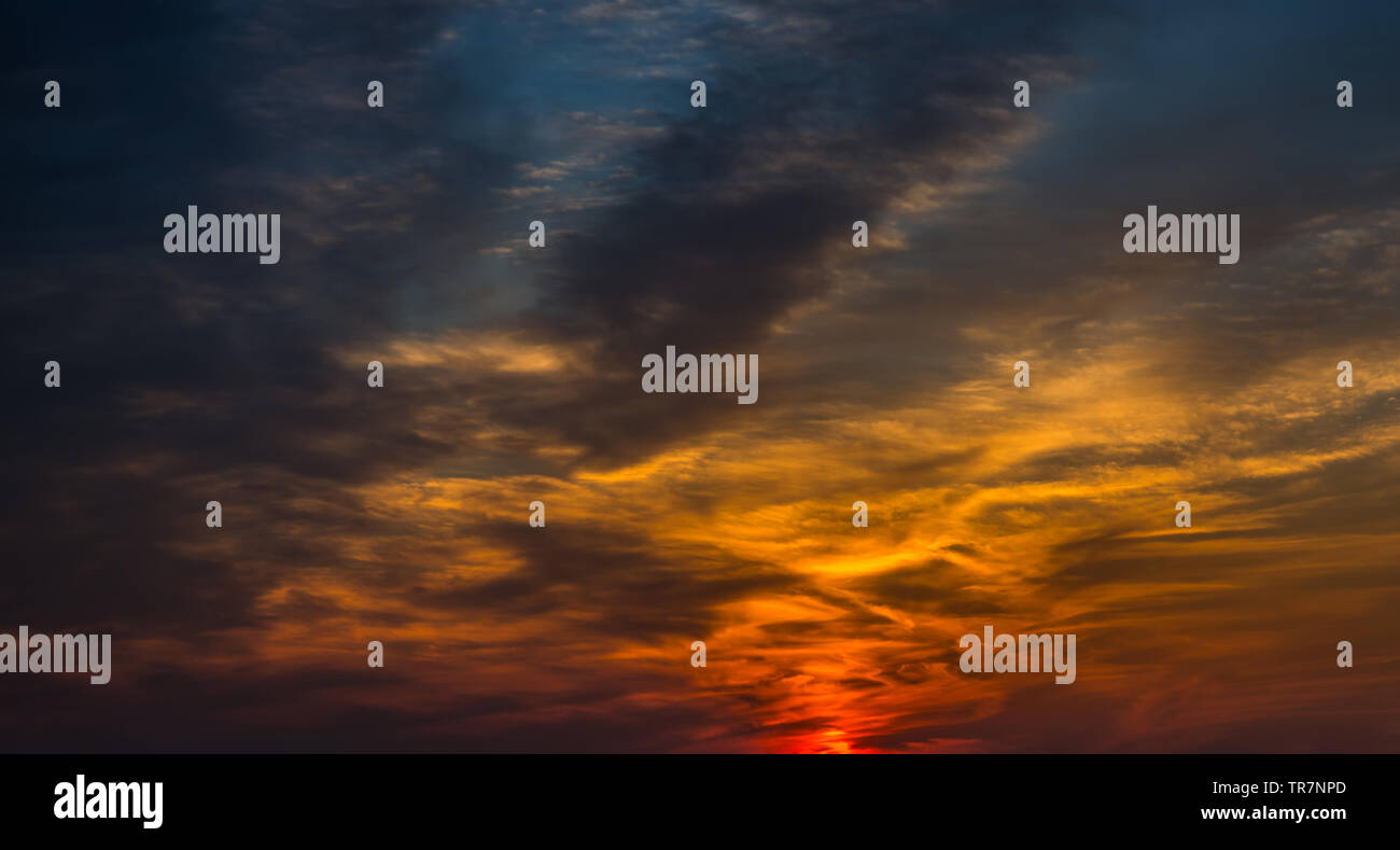 Dramatic sunset sky with orange colored clouds Stock Photo - Alamy