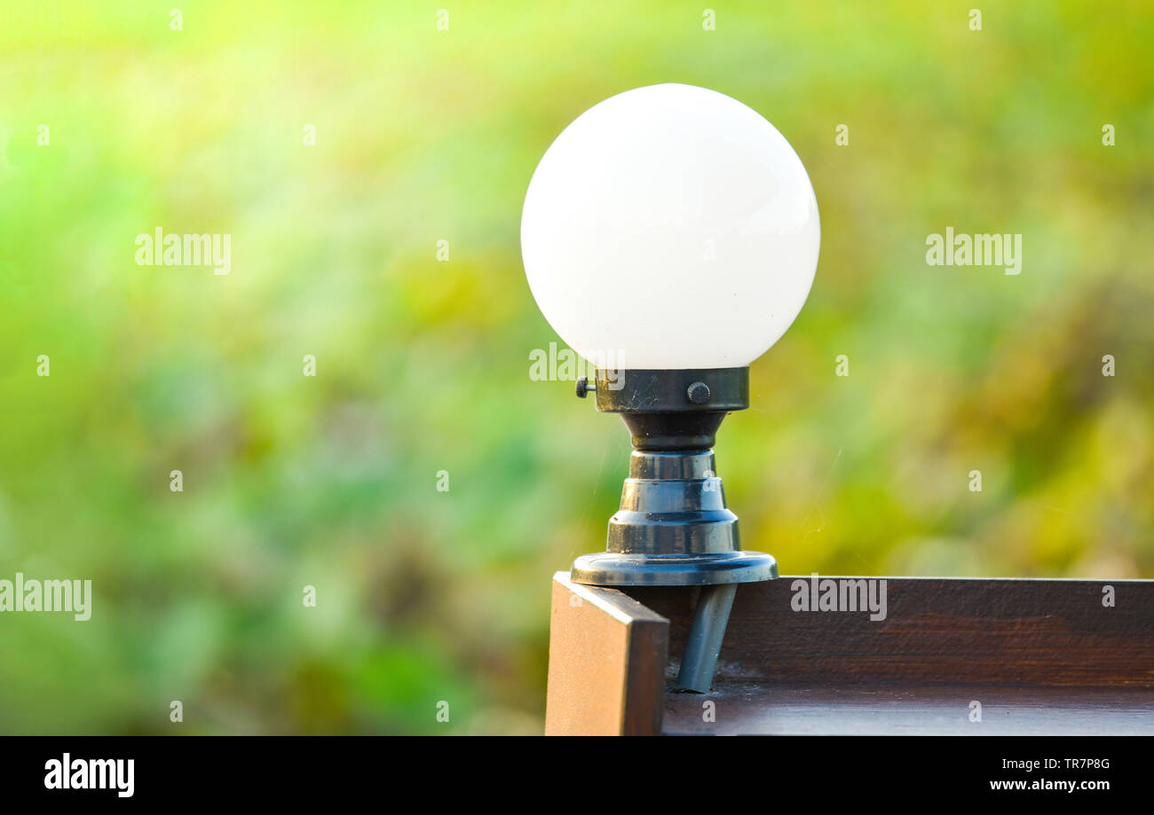 Lamp garden on wooden and nature green background / Round glass lamp ...