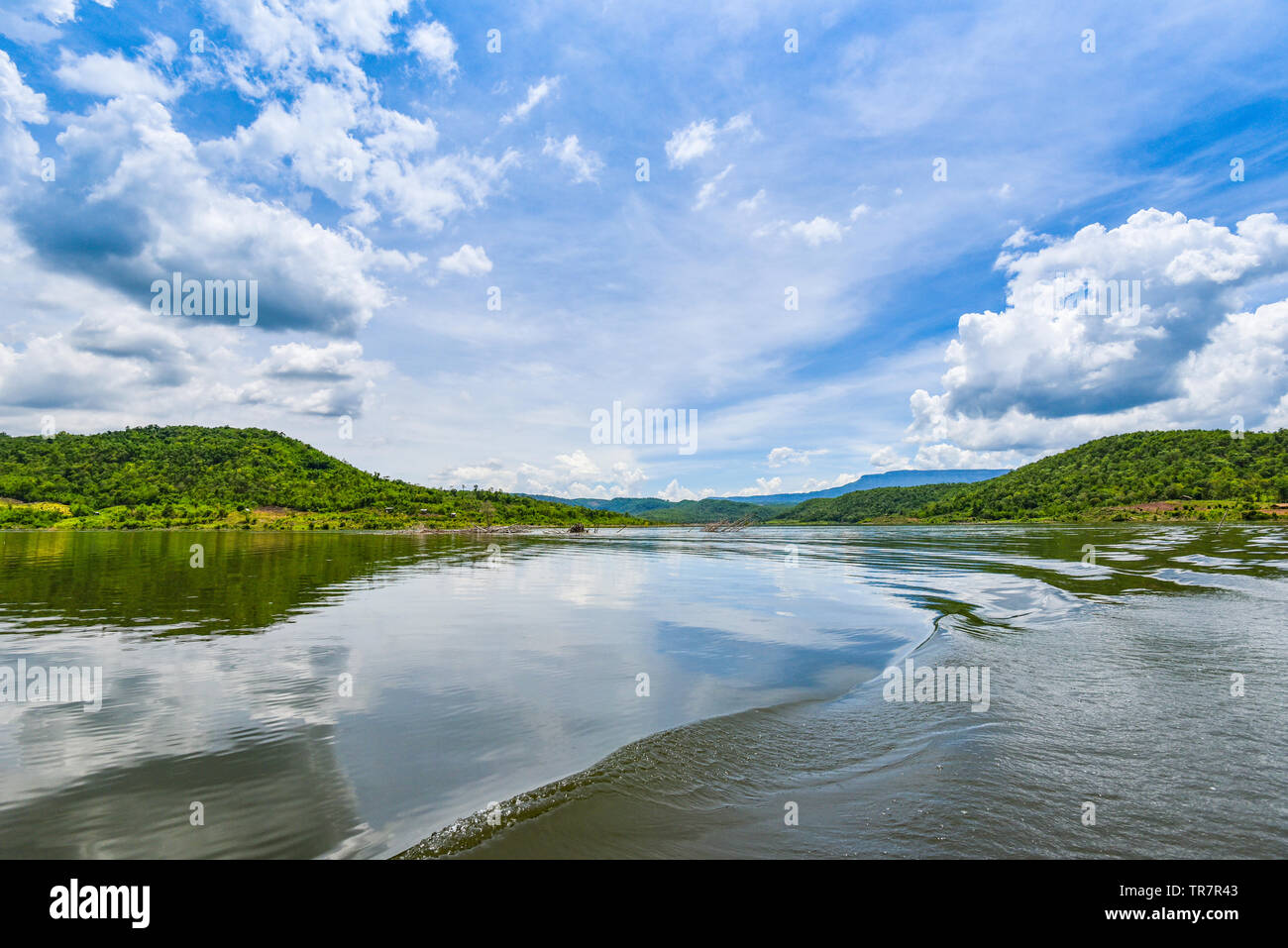 Landscape river view from fishing boat wave stern on bright day ...