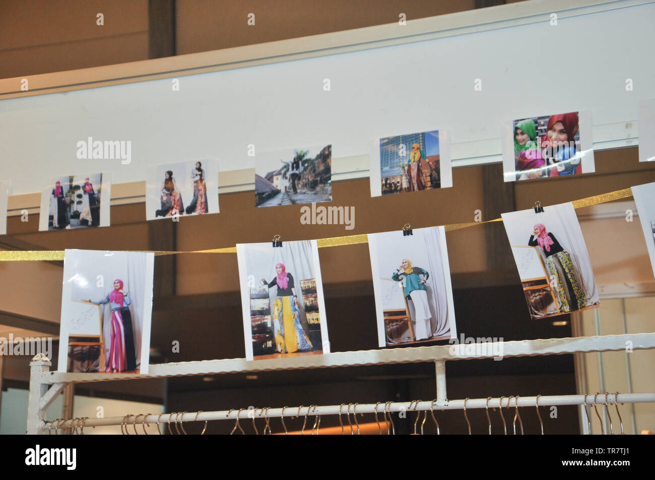 Pictures of models wear muslim clothes hang at a booth during Indonesia ...
