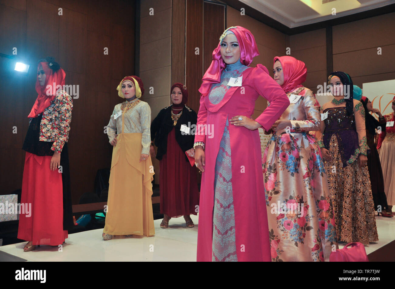 Participants of a fashion competitions stand on the catwalk during ...