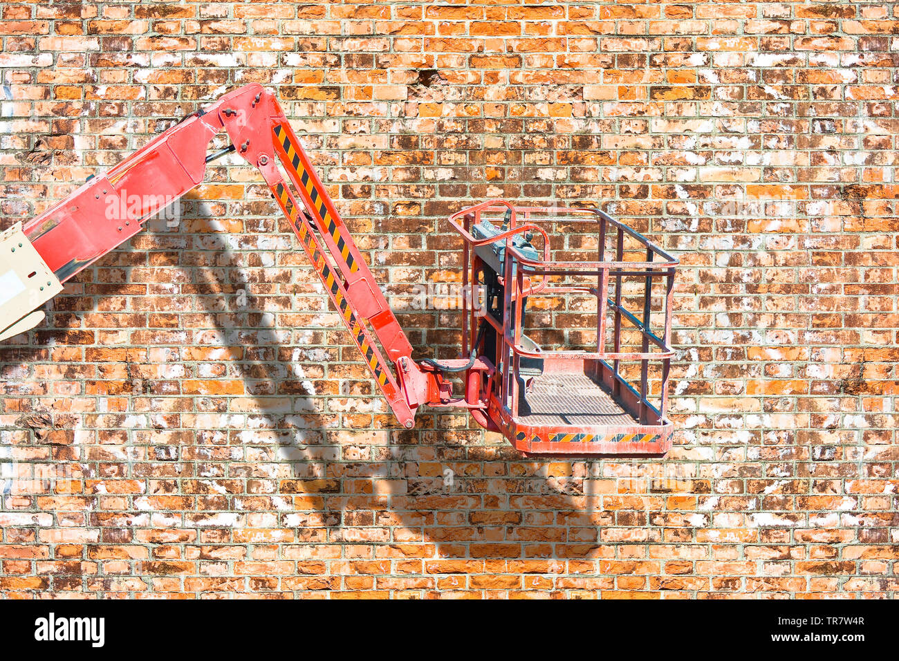 Aerial platform for repairing works against a brick wall Stock Photo ...