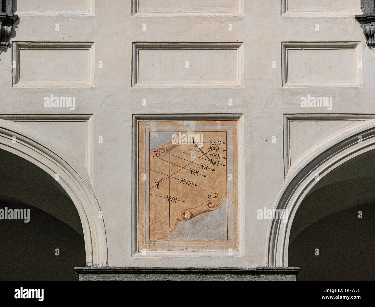architecture: sundial painted on a facade of a building between two ...