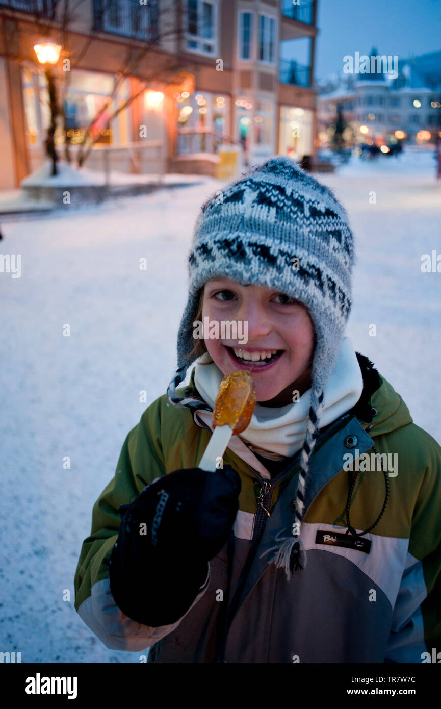 Boys eating a maple syrup snow popsicle. Ski Fest Tremblant Quebec ...