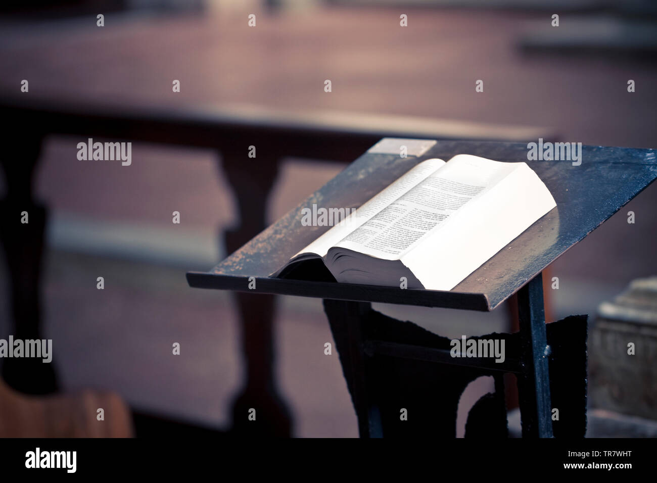 Open book above a lectern in church Stock Photo - Alamy