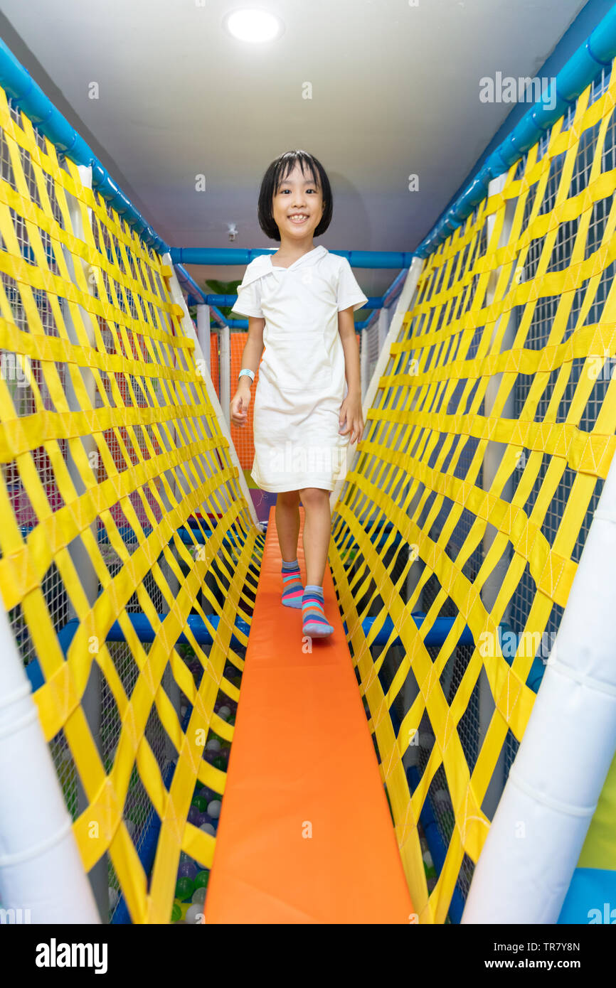 Asian Chinese little girl playing at indoor playground alone Stock ...