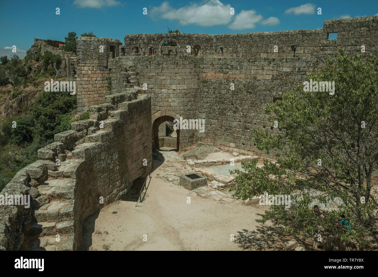 Stairway over stone wall with gate and rocky courtyard at the Sortelha ...