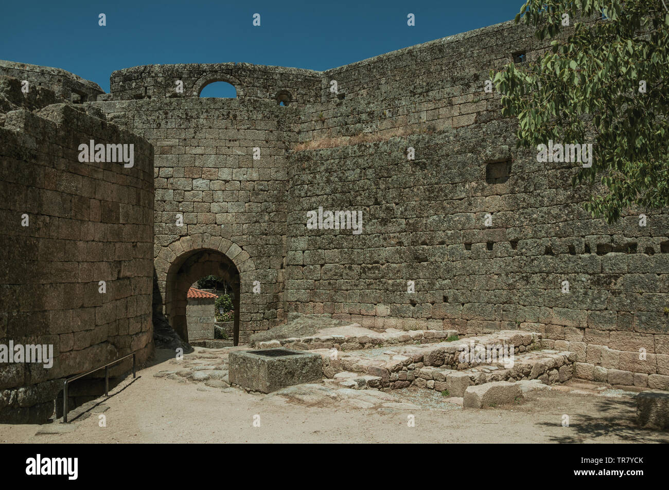 Open gate on stone wall in front of inner rocky courtyard at the ...